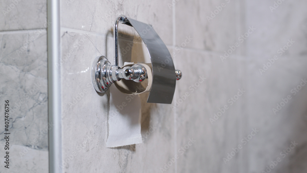 No more toilet paper. The last piece of paper on a roll in a clean and ...