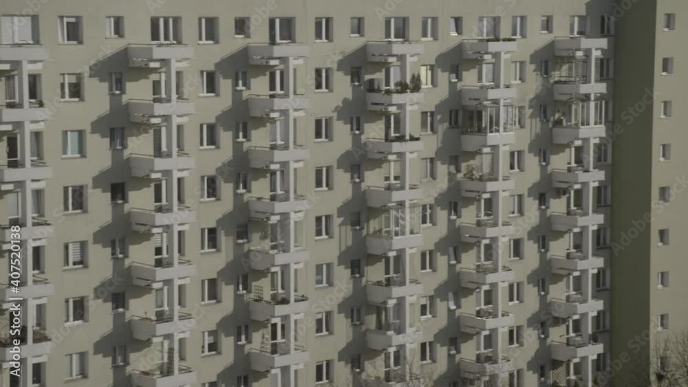 A telephoto clip of a populated apartment building, then camera moves ...