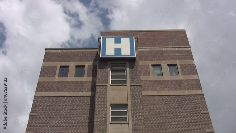 ‘H’ is for Hospital. Time lapse clouds. Detail of hospital building ...