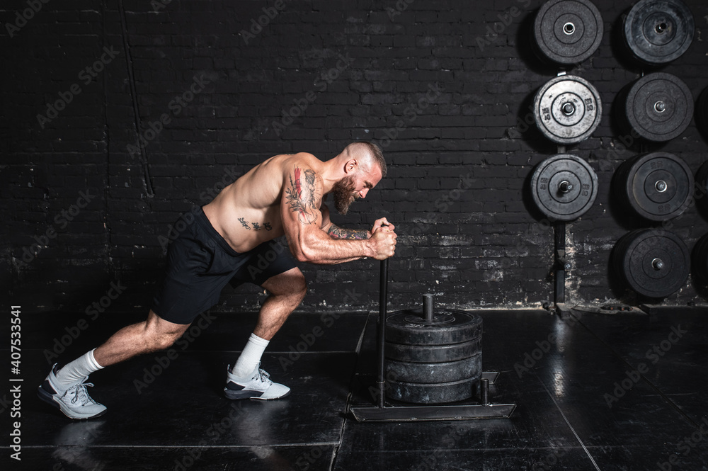 Young strong active sweaty muscular fit man with big muscles pushing ...
