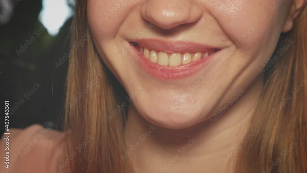 Extreme close up view face part of smiling female revealing healthy ...