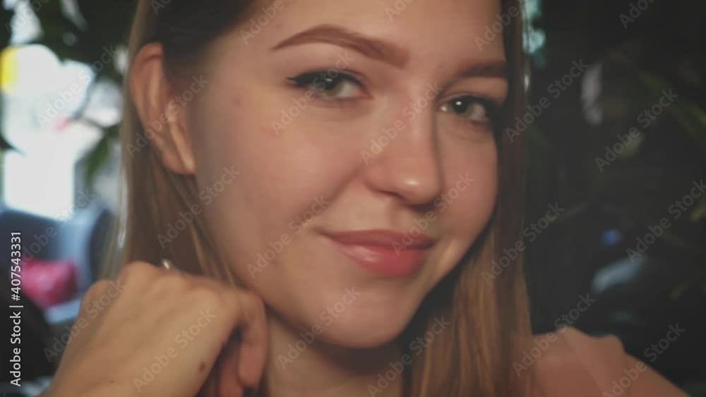 Lady with nice smile looks into camera after she threw her hair from ...