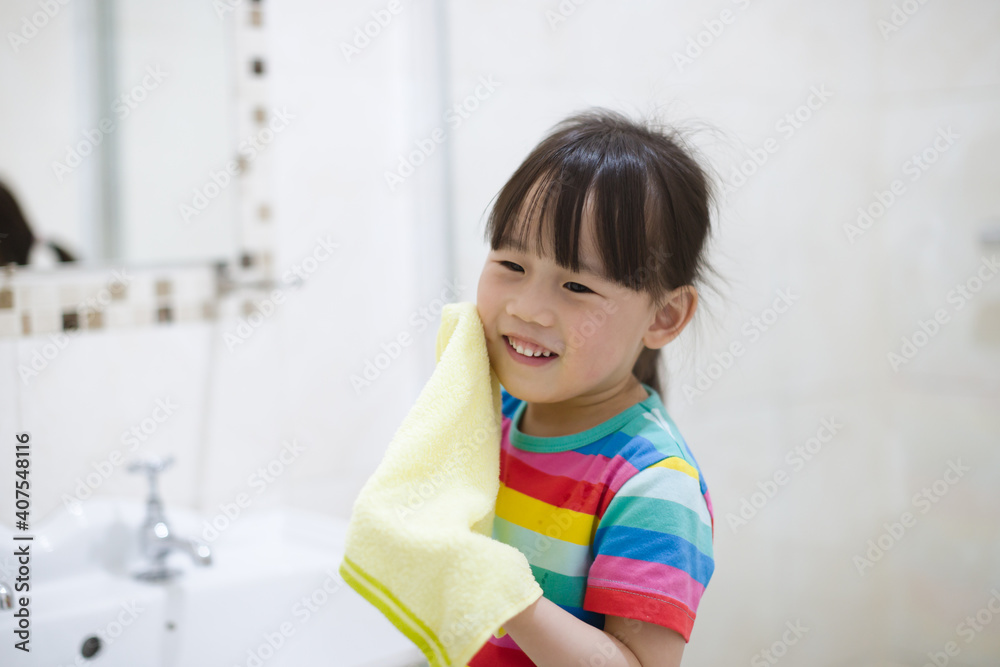 young girl washing face by herself in bathroom Stock Photo | Adobe Stock
