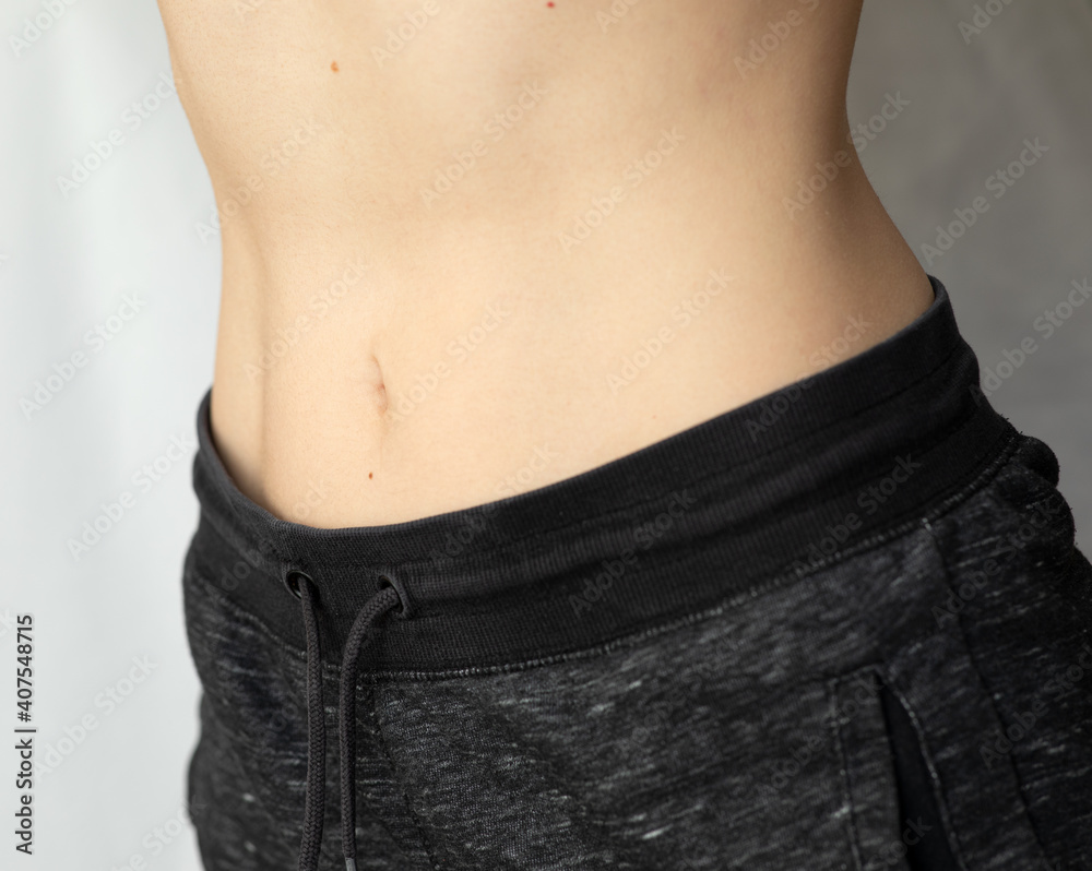 Foto de Flat female belly. Woman showing her flat belly. Body parts ...