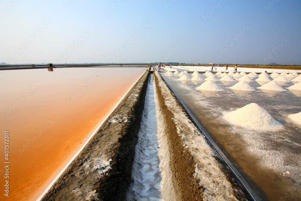 Heap of sea salt in salt farm ready for harvest with farmers ...