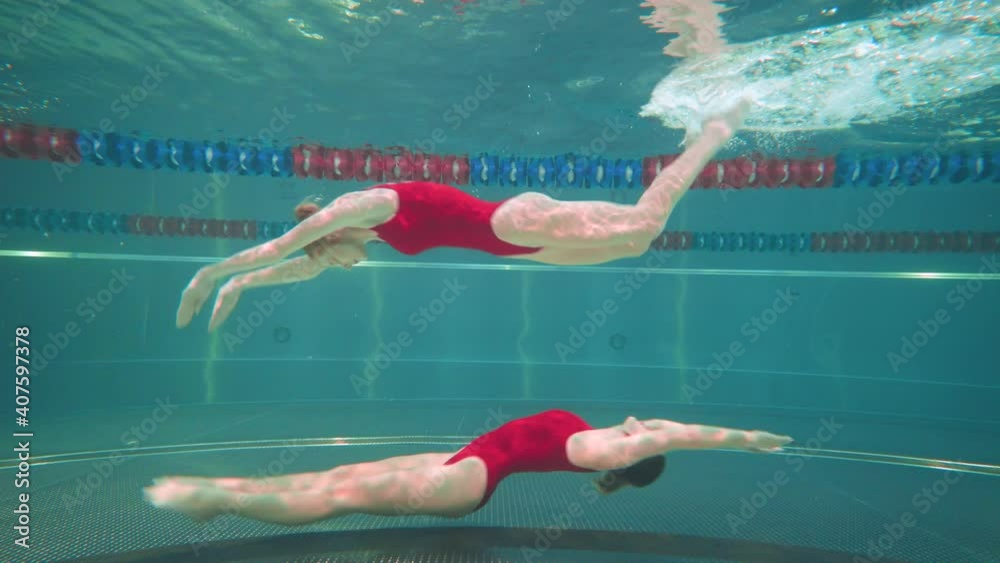 Professional females swimmers in the pool, young womans perform the ...