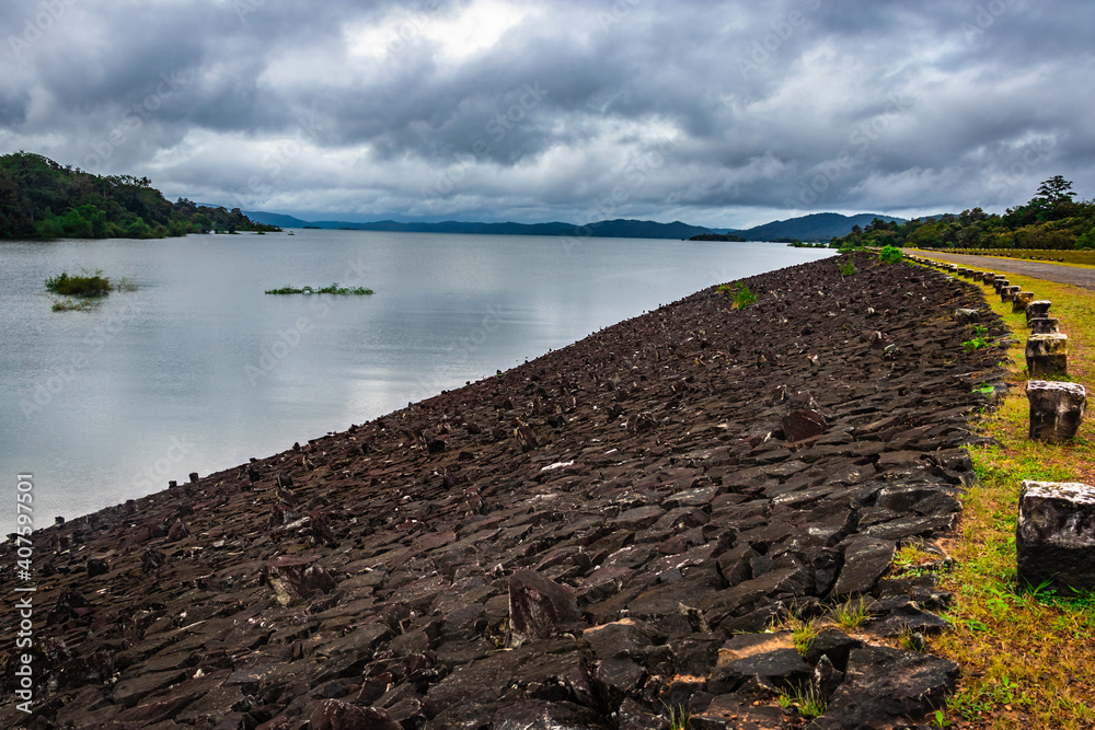 river serene back water with stone edge and dramatic cloudy sky Stock ...