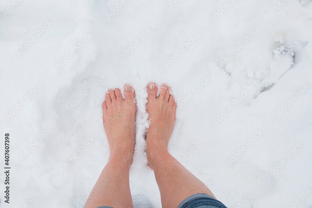 Girl bare feet on white cold snow in winter on a frosty day. Health ...