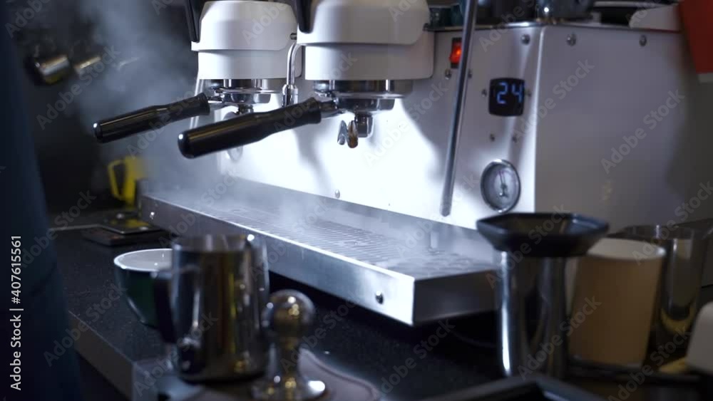 Barista makes coffee in professional machine in restaurant kitchen ...