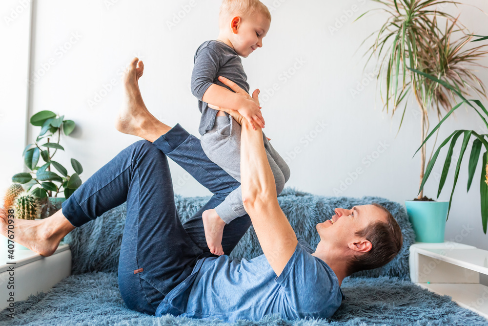 Happy baby boy flying in father's arms lookingdad holding lifting cute ...