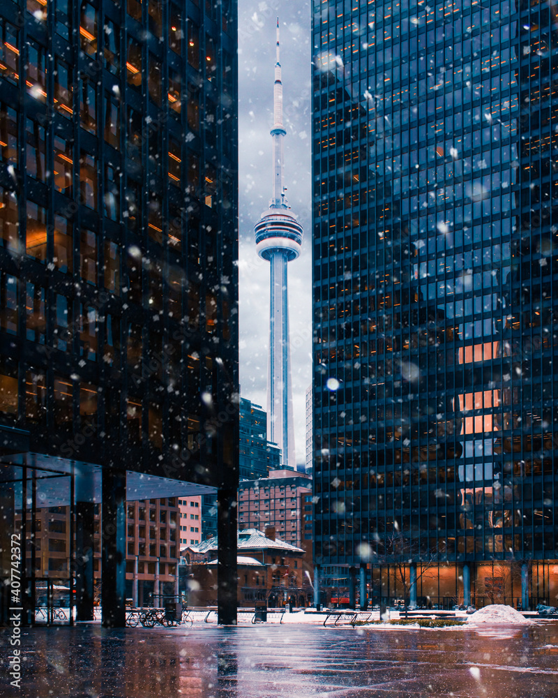 Beautiful Toronto tower with skyscrapers during snowfall Stock Photo ...