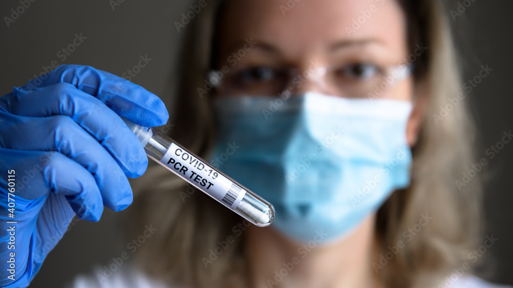 COVID-19 PCR test tube, woman in face mask holds coronavirus swab ...