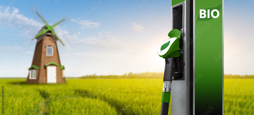 Biofuel filling station on a background of green field with windmill ...