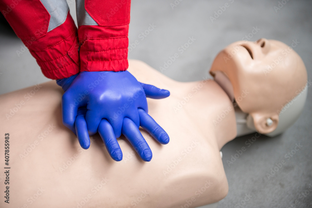 Paramedic practicing bls and cpr on a mannequin. Stock Photo | Adobe Stock