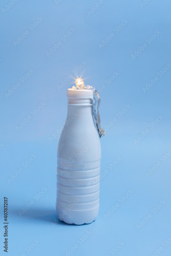 Handmade lighting lamp: plastic bottle, light bulb are on a blue ...