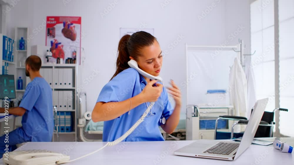 Nurse answering at hospital call checking the result of patient x-ray ...