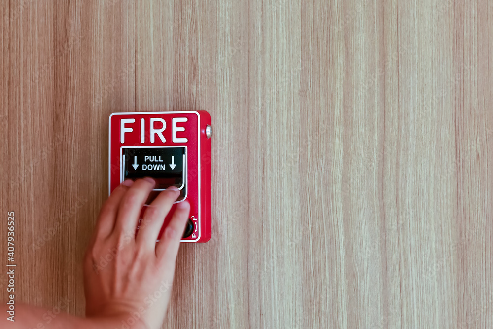 The hand of man is pushing fire alarm on the wall. Hand of man pushing ...