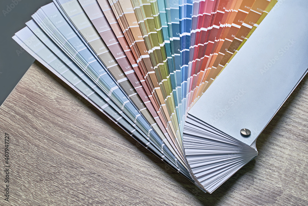 Color wheel palette for choosing paint tone. Various colors on wooden ...