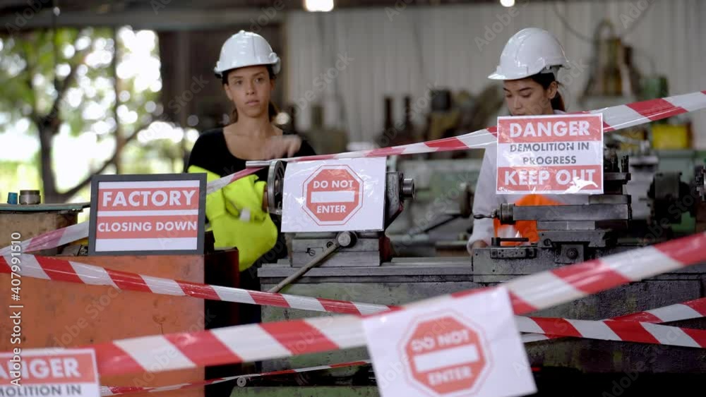 factory worker women walking out at factory. workplace has signage not ...
