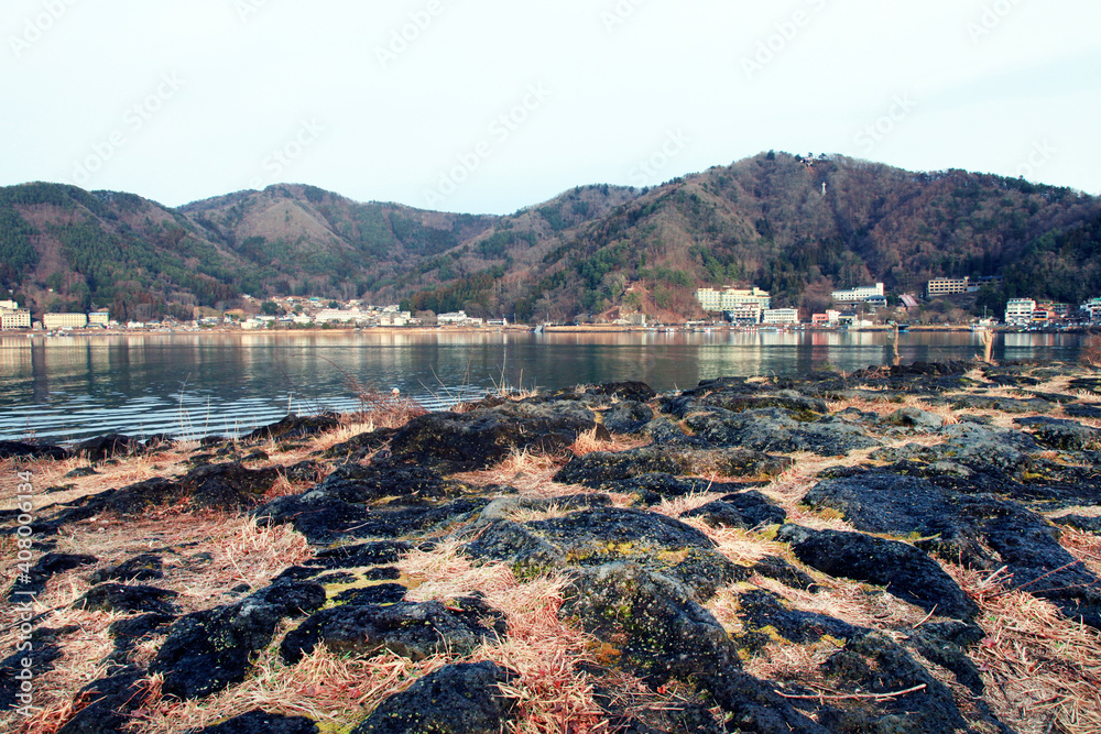 Volcanic lava rock at the edge of Lake Kawaguchi near Mount Fuji ...