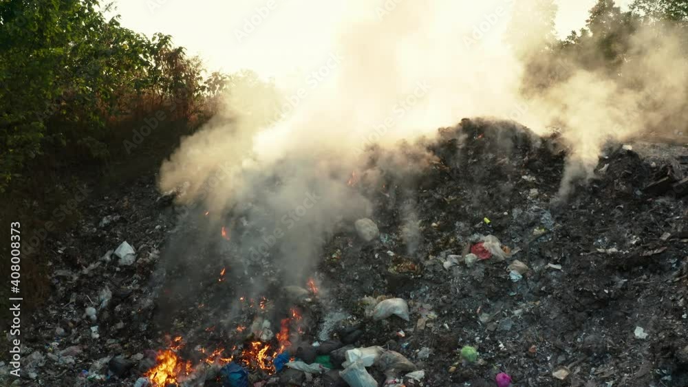 Garbage and fire burn in landfill. Also call trash, waste, rubbish ...