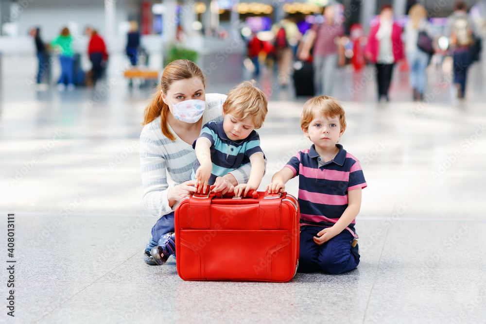 Young mother with two little kid boys at airport. Cute preschool ...