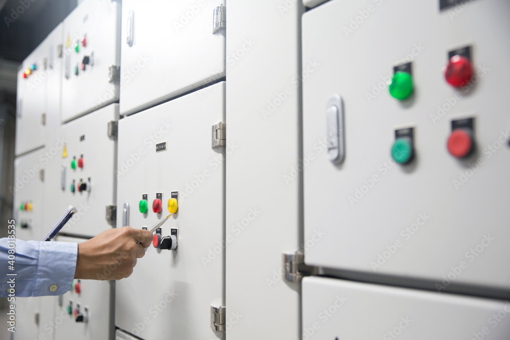 Electrical engineer checking electrical voltage at circuit breaker of ...