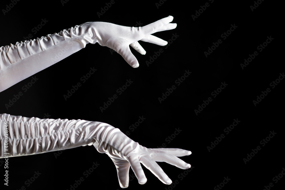 Hand gestures. Lady illusionist, beautiful hands in long white gloves ...