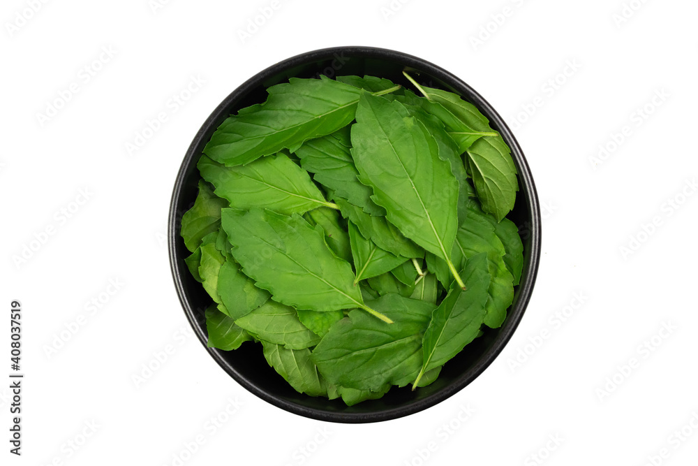 Tulsi or Holy basil leaf in black bowl isolated on white background top ...