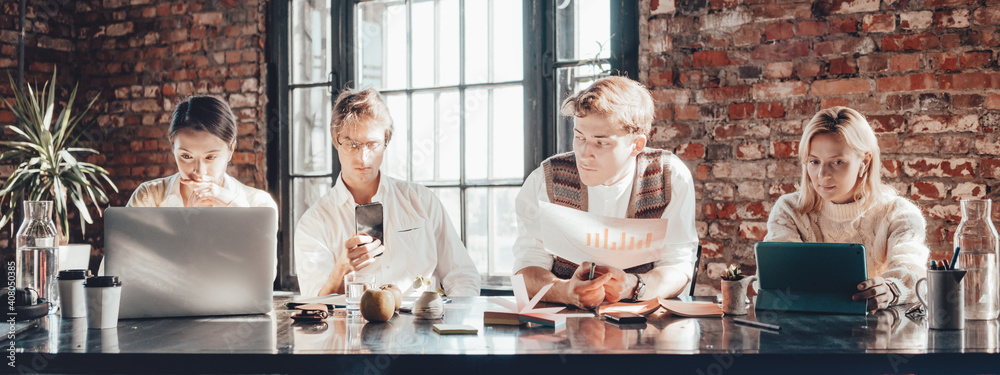 Office business team concept. Four teammates sitting in a line and ...