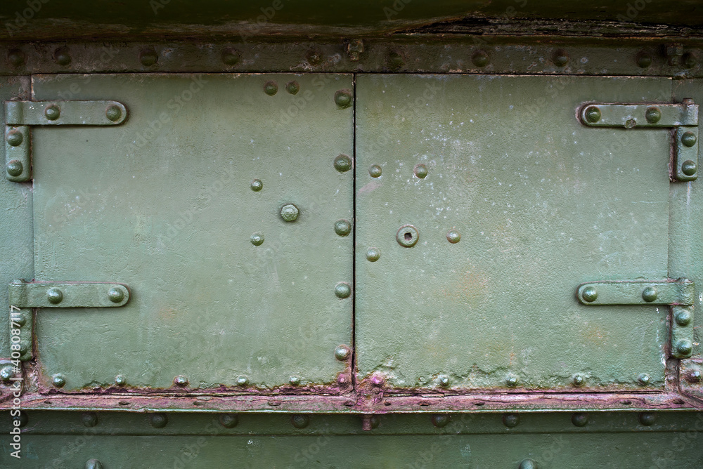Abstract green metal background with bolts and rivets, copy space. Old ...