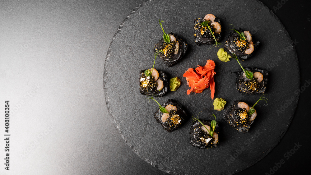 Sushi roll with nori, black rice, crab meat, cucumber, avocado, smoked ...