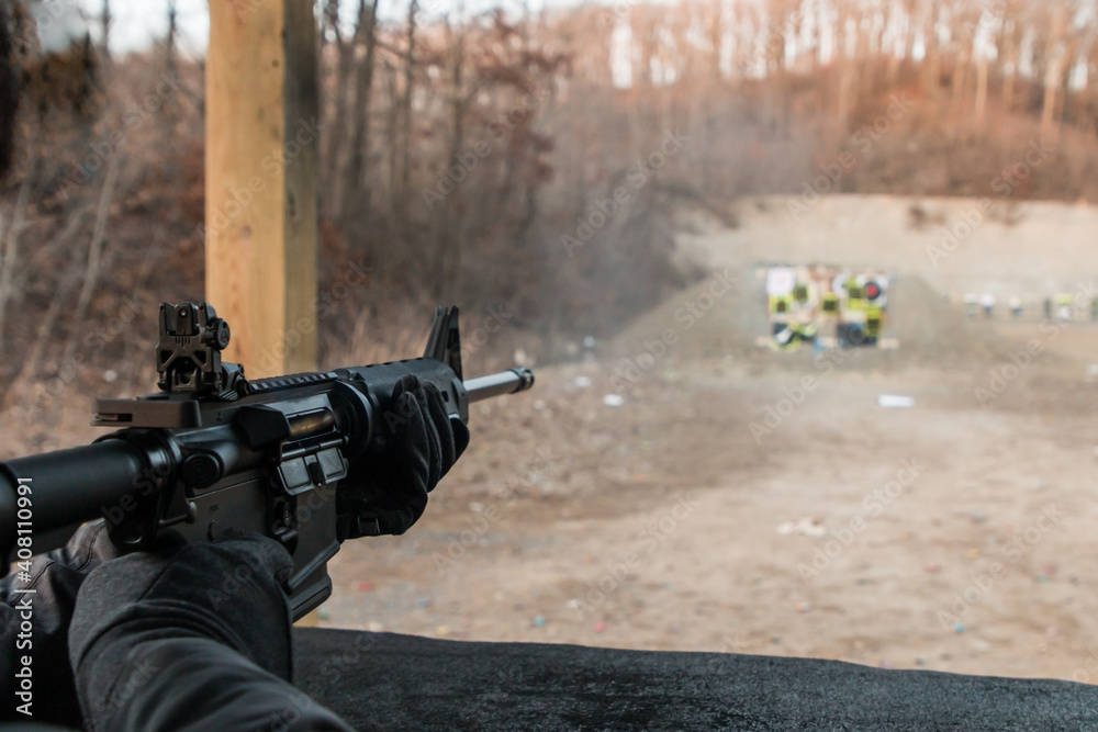 Person shooting a semi-automatic AR-15 assault weapon rifle at an ...