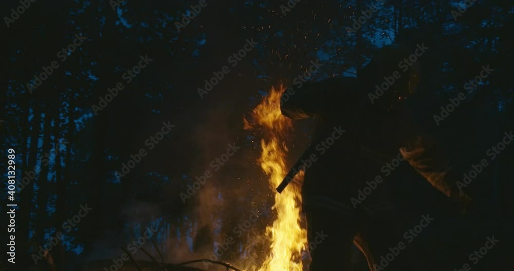 Firemen jumping over fire in dense forest, fire fighter with safety ...