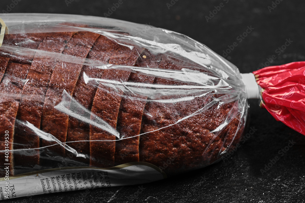 Sliced black rye bread in plastic bag on dark background Stock Photo ...