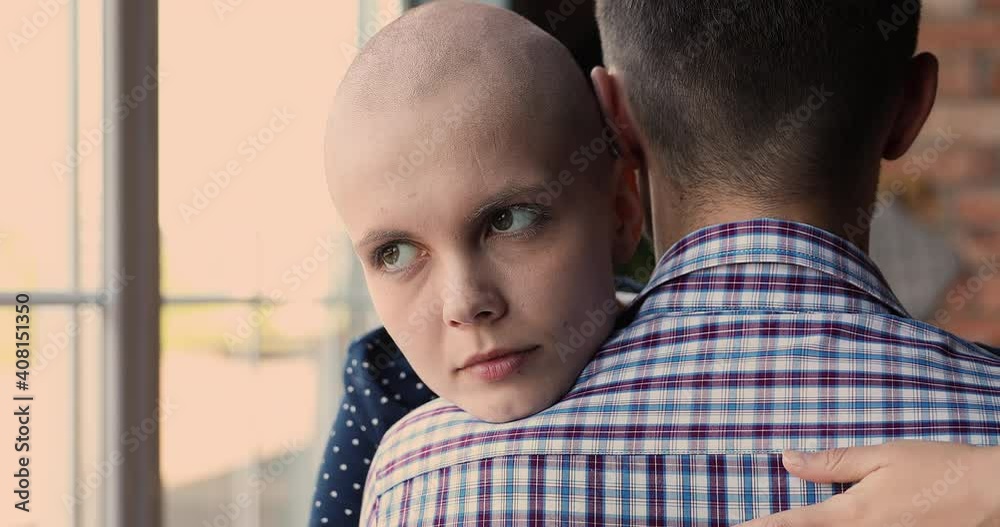 Close up face of bald female cancer patient hugging beloved man, rear ...