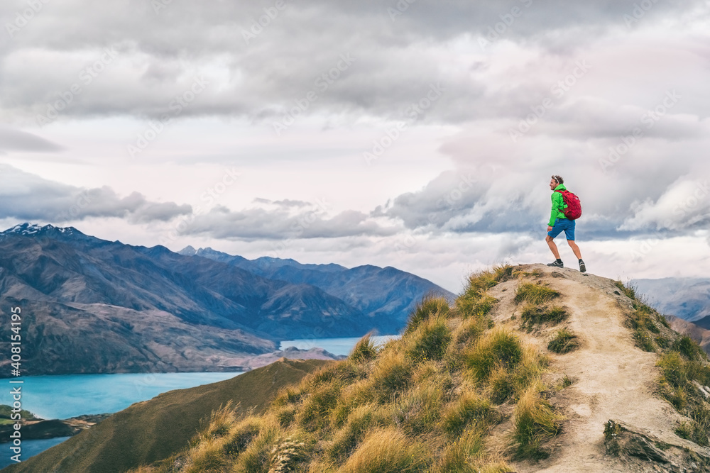 Hiking man adventure travel explorer hiker on mountain summit looking ...