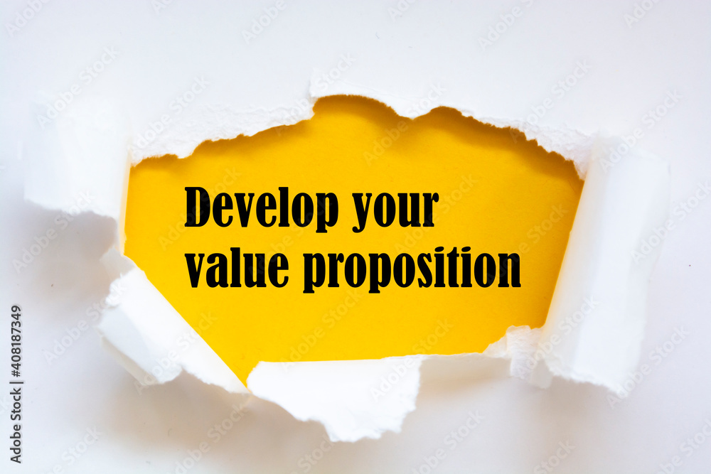 Develop your value proposition slogan written under torn paper on ...