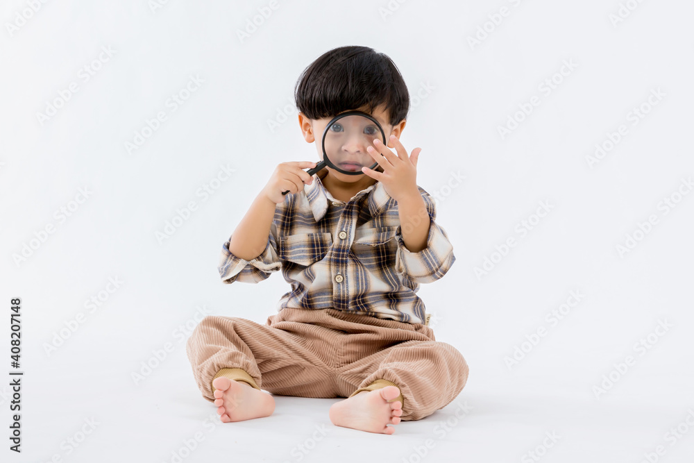 Child holding magnifying glass on white background. Boy with a ...