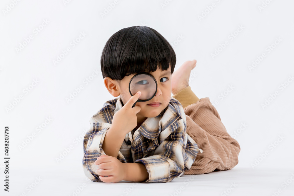Child holding magnifying glass on white background. Boy with a ...