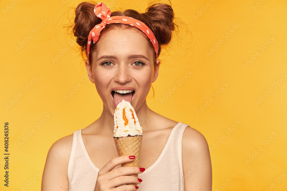 Portrait of attractive, lovely girl with two buns. Wearing white tank ...