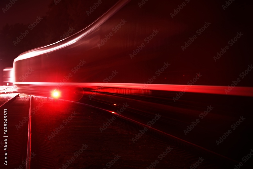 Large cargo train with goods leaving the terminal at night, wagons ...