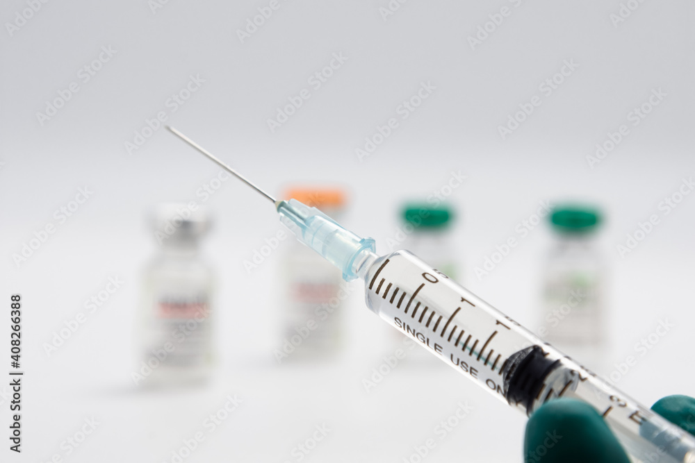 Closeup syringe with vaccine against covid-19 on blurred background of ...