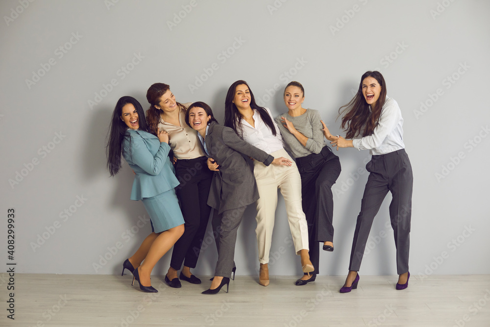 Team of excited cheerful confident well-dressed businesswomen having ...