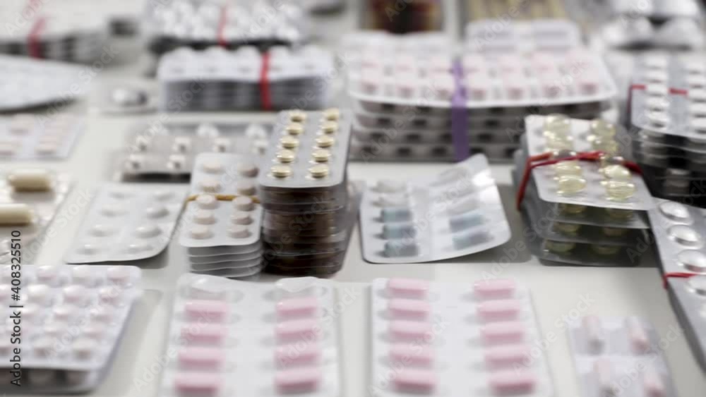 Pan shot over desk full of stacks of medication blisters Stock Video ...