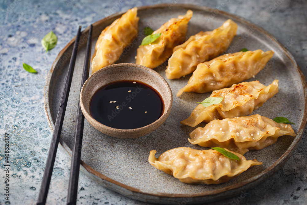 Asian dumplings with soy sauce, sesame seeds and microgreens ...
