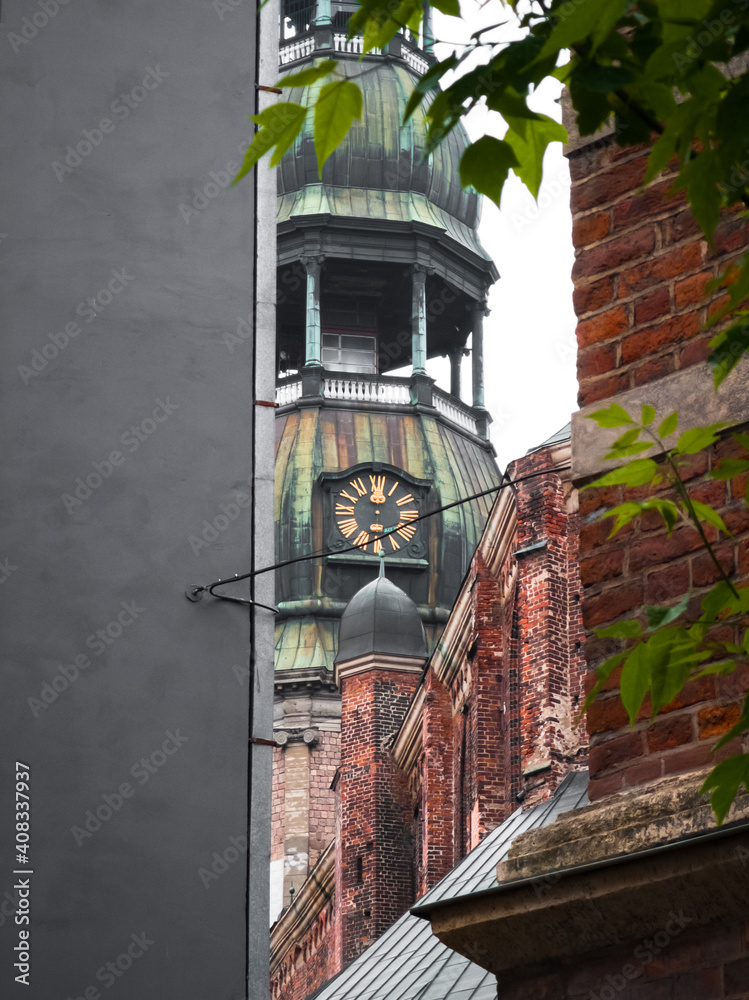 Medieval clock on St. Peter church's tower. Stock Photo | Adobe Stock
