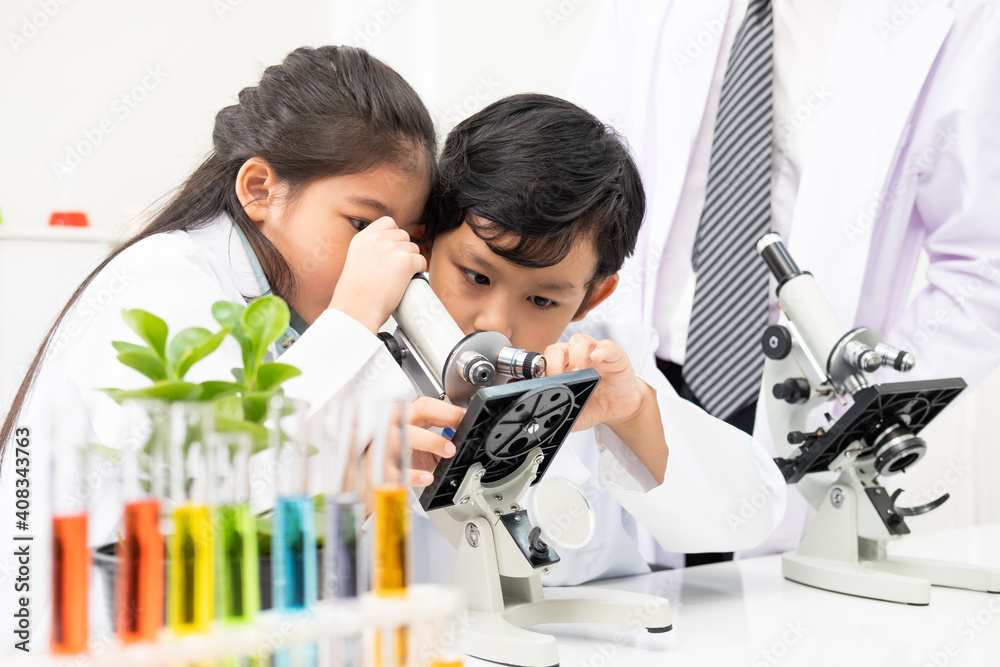 Young Asian kids wearing white scientist gown and do chemical test tube ...