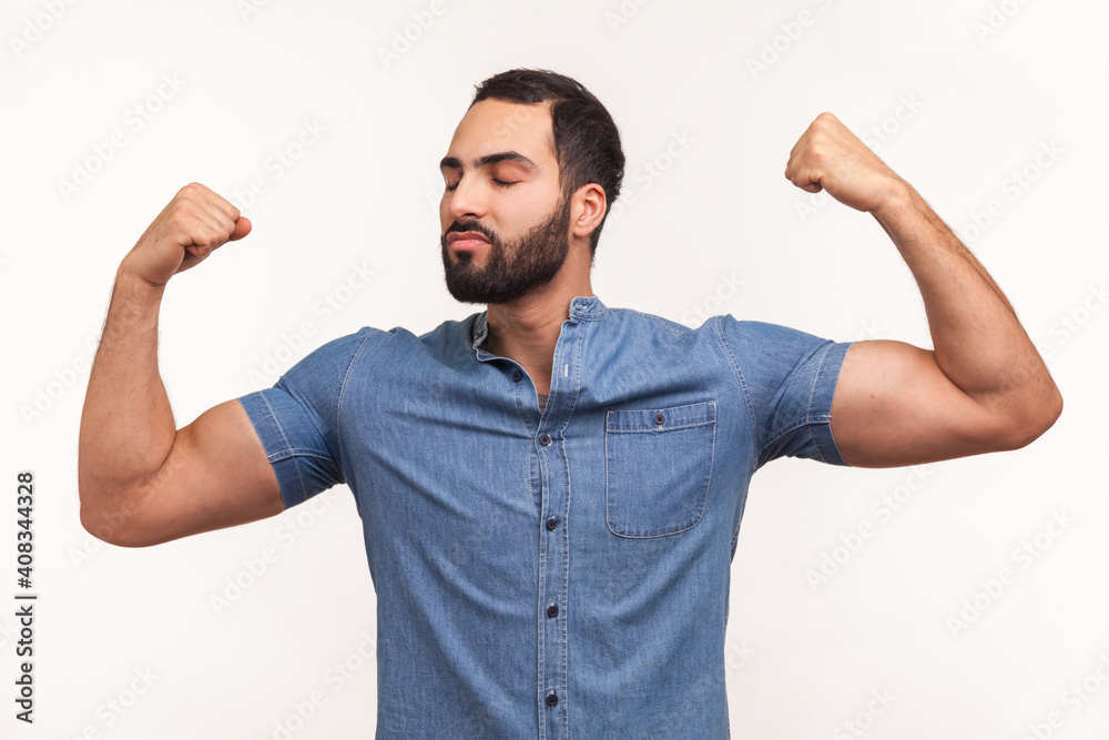 Strong and independent self confident man with beard showing biceps ...