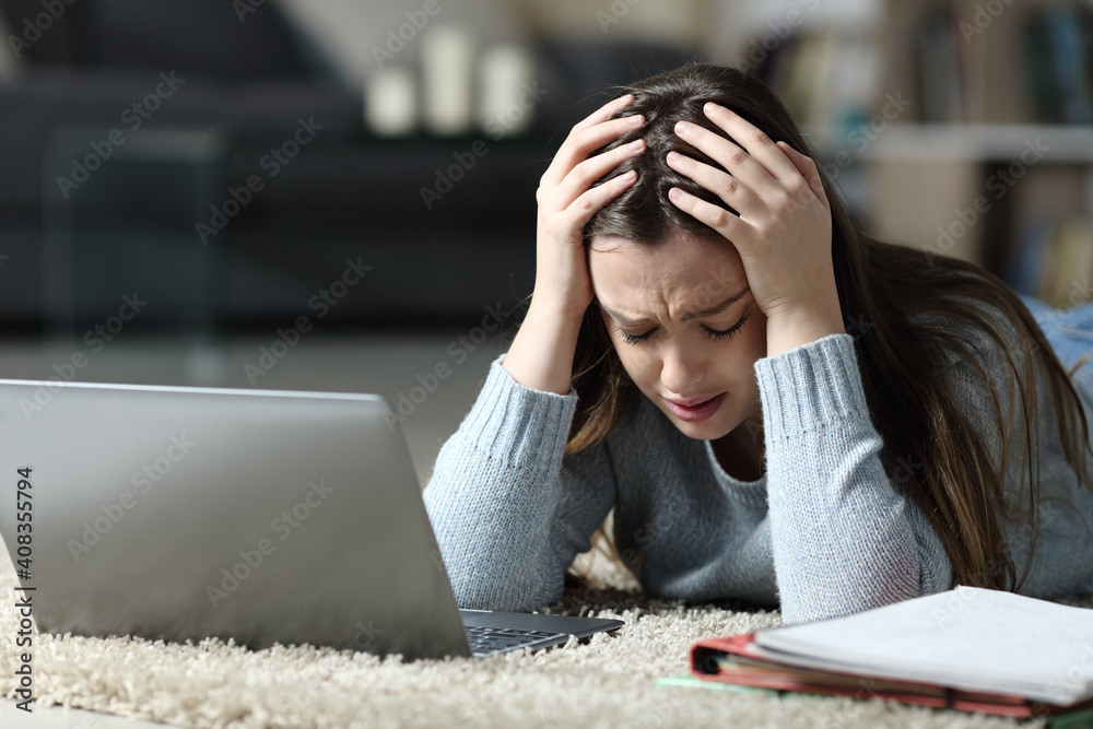 Sad student with laptop and notebook complaining at home Stock Photo ...